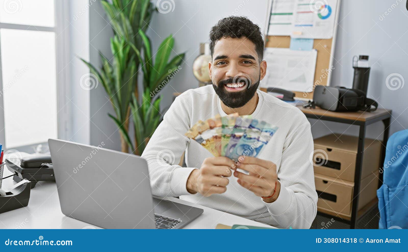 Hispanic Man Smiling in Office Holding Canadian Dollars Stock Photo ...