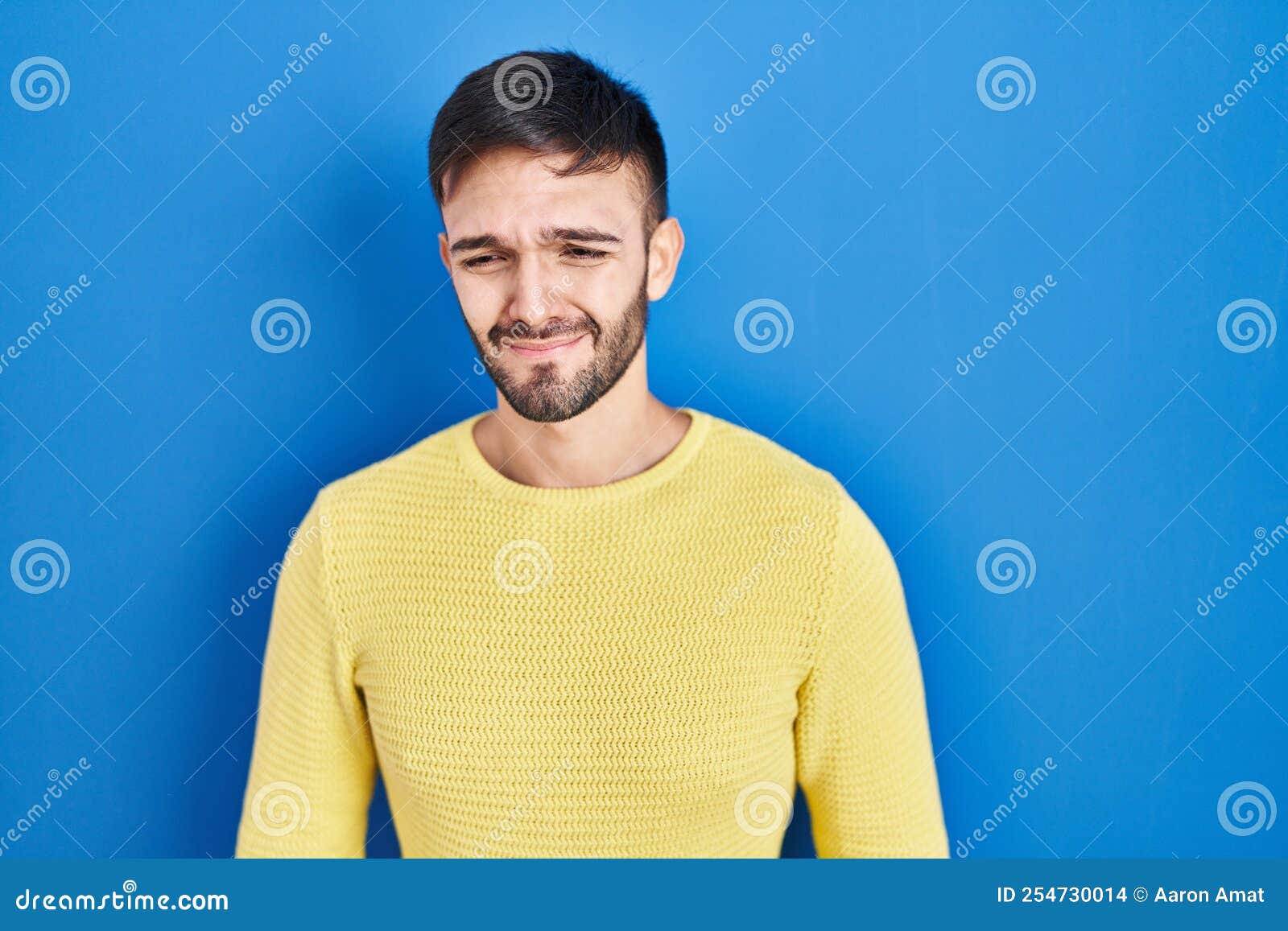 Hispanic Man Standing Over Blue Background Depressed and Worry for ...