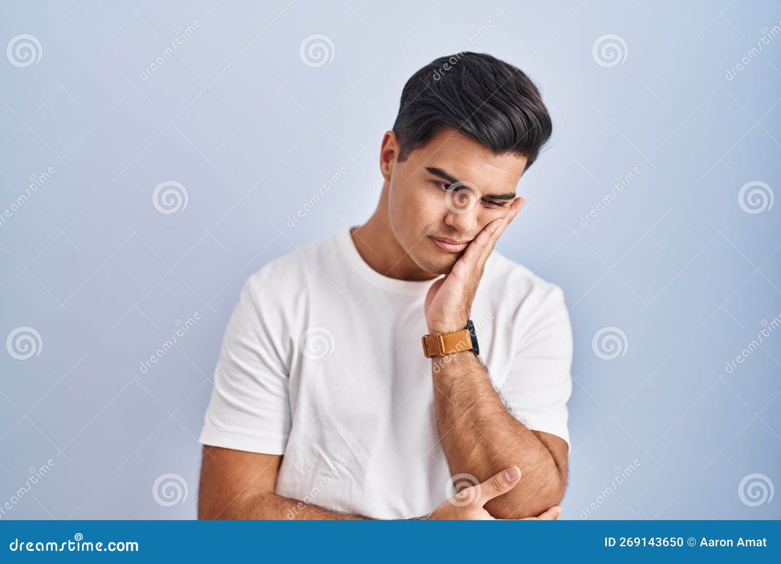 Hispanic Man Standing Over Blue Background Thinking Looking Tired and ...