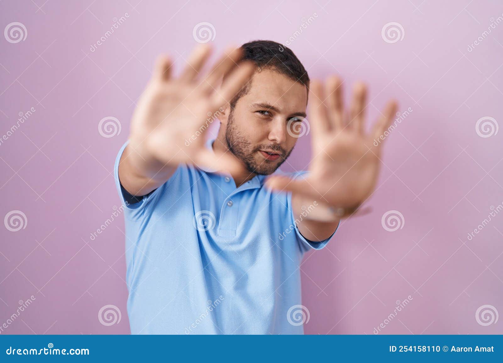 Hispanic Man Standing Over Pink Background Doing Frame Using Hands ...
