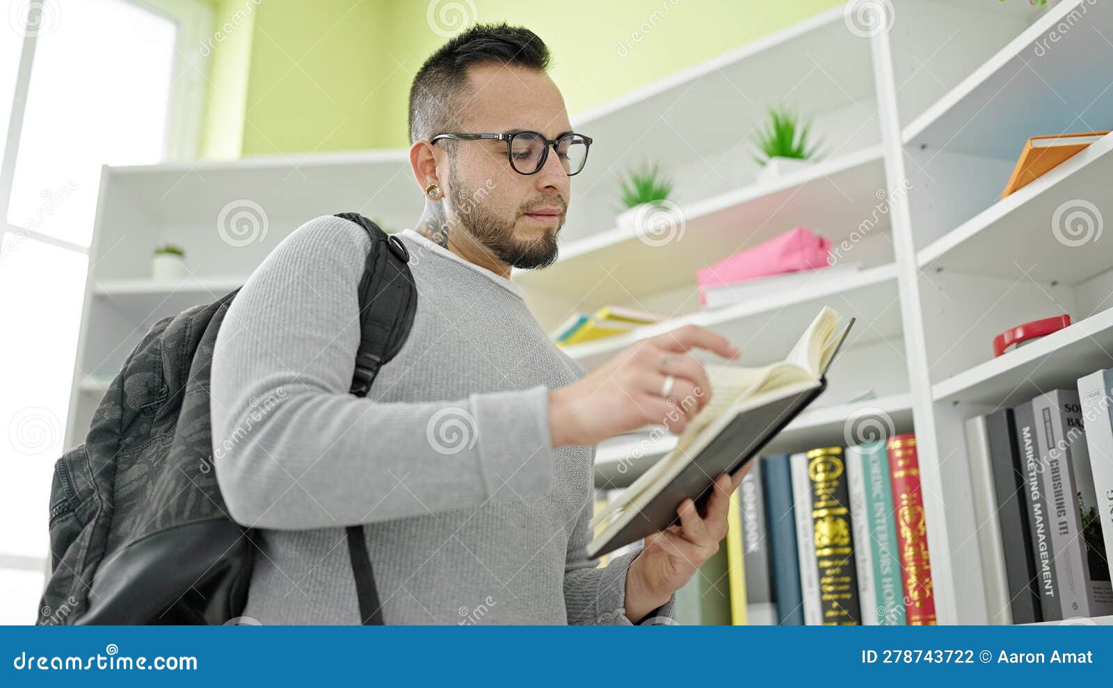 Hispanic Man Standing Reading Book at Library University Stock Photo ...