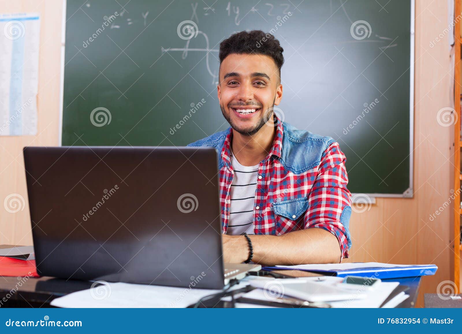 Hispanic Man Using Laptop Computer, Student in University Classroom at ...