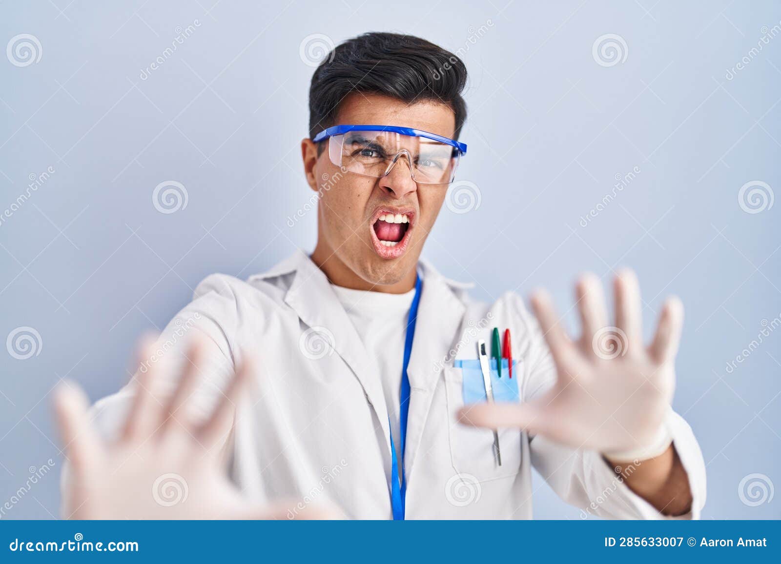 Hispanic Man Working As Scientist Afraid and Terrified with Fear ...