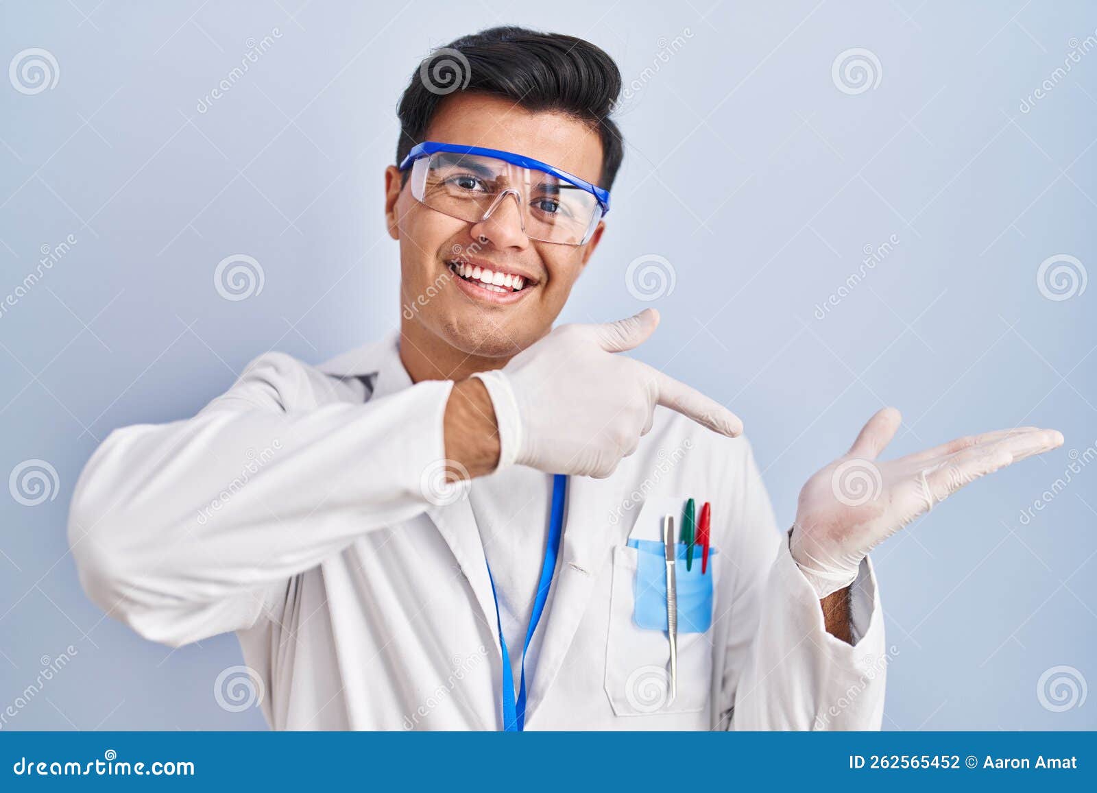 Hispanic Man Working As Scientist Amazed and Smiling To the Camera ...