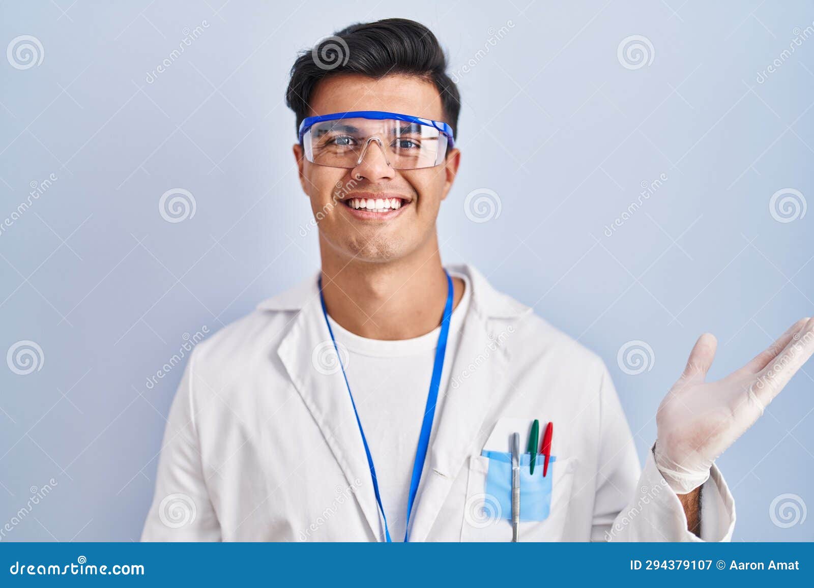 Hispanic Man Working As Scientist Smiling Cheerful Presenting and ...