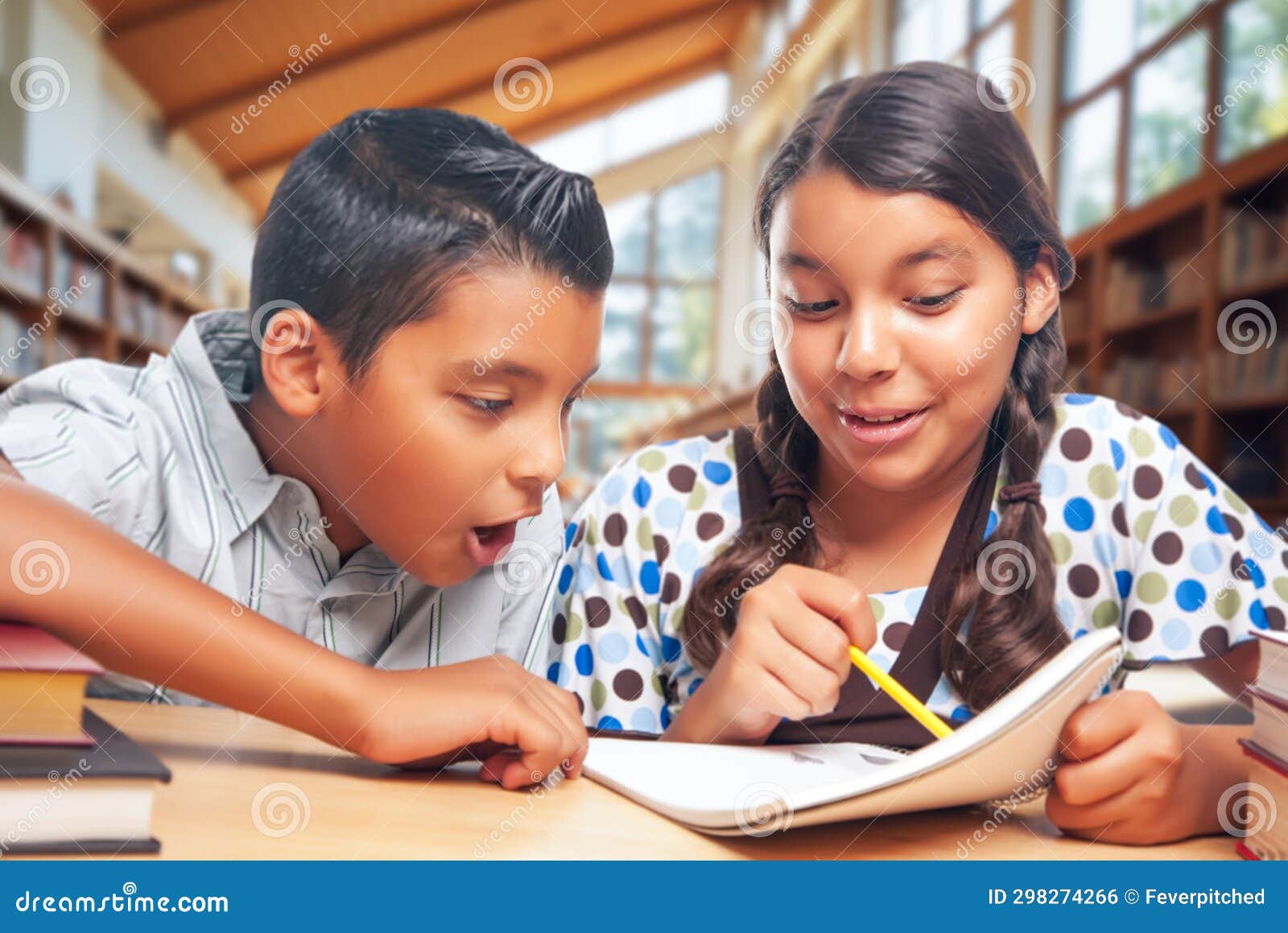 Hispanic School Kids Doing Homework Together in the Library Stock Photo ...