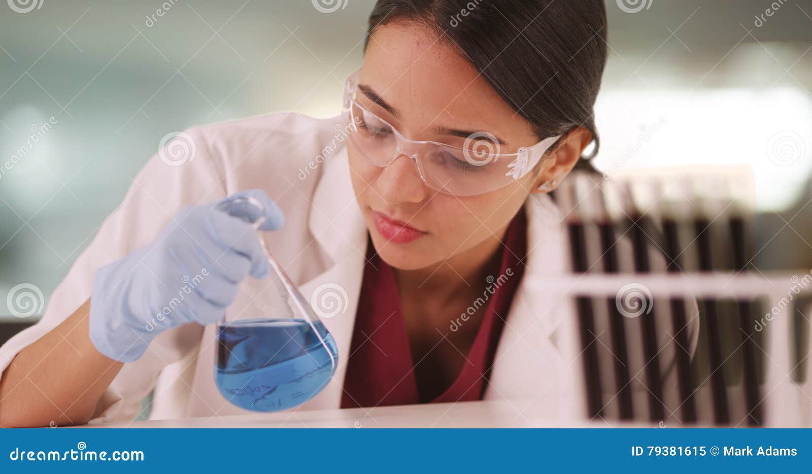 Hispanic Scientist Looking at Liquids in Vials Stock Image - Image of ...