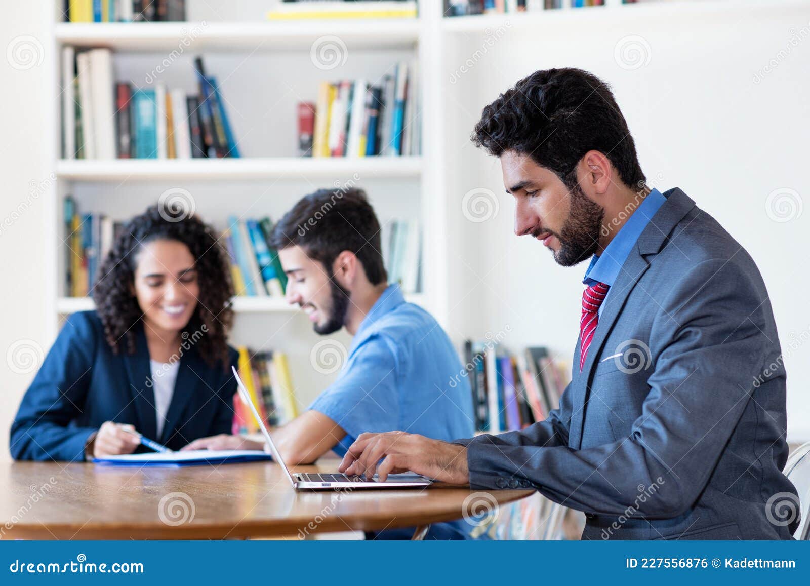 Hispanic Software Engineer Working at Computer with Group of Latin ...