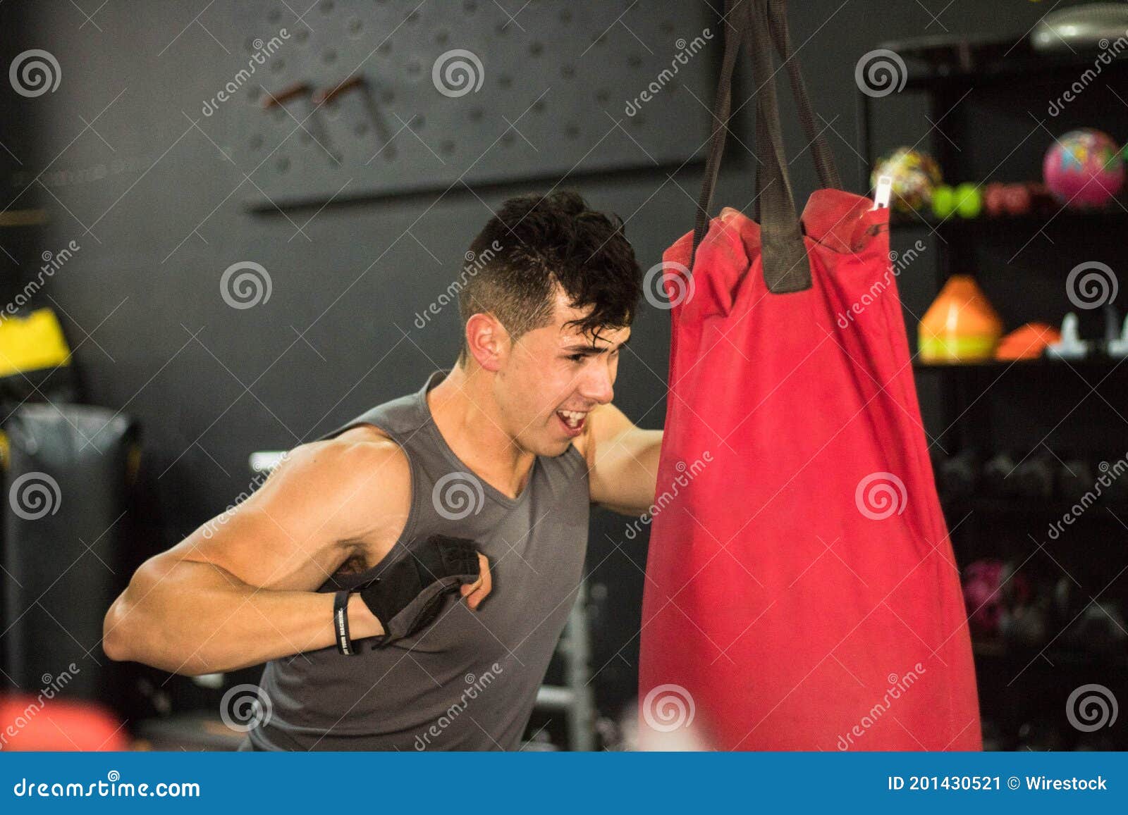 Hispanic Sporty Man Punching a Boxing Bag Stock Image - Image of male ...