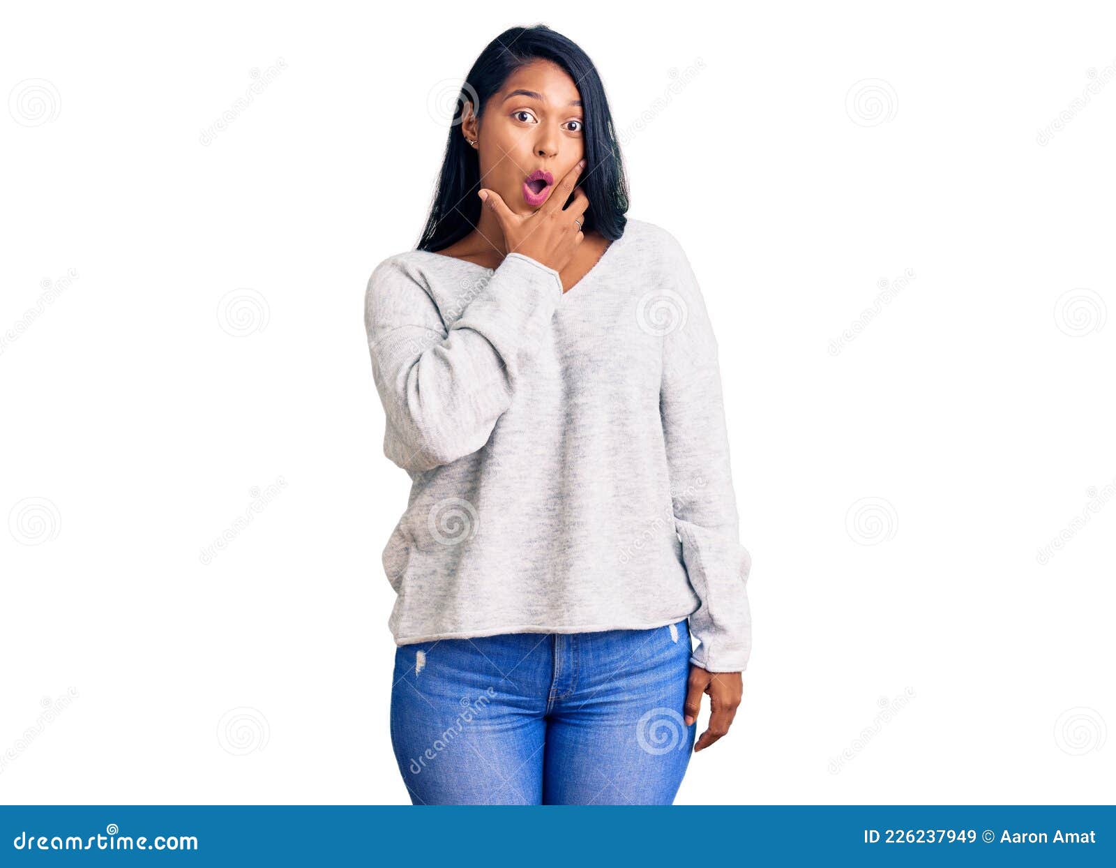 Hispanic Woman With Long Hair Wearing Casual Clothes Looking Fascinated