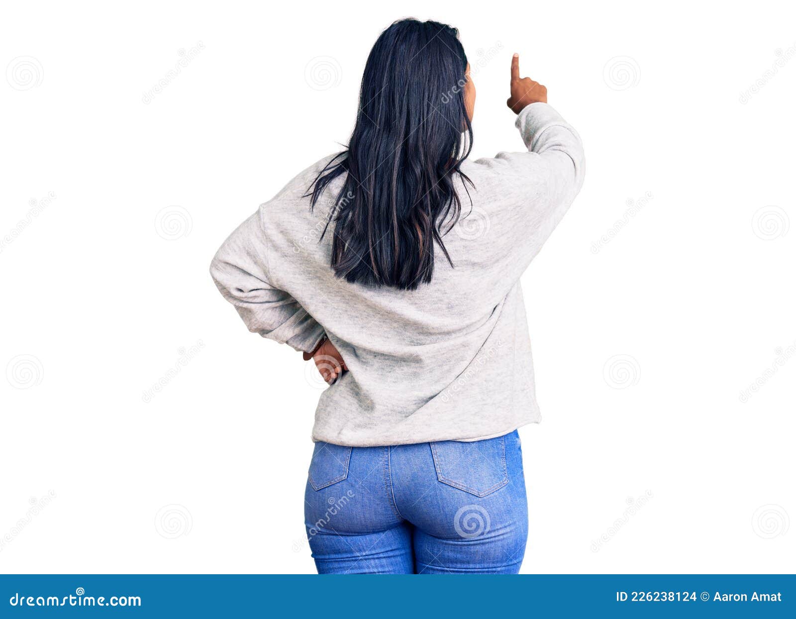 Hispanic Woman With Long Hair Wearing Casual Clothes Posing Backwards