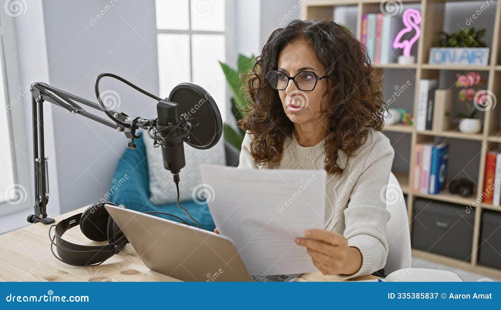 Hispanic Woman Reading Script in Radio Studio with Microphone and ...