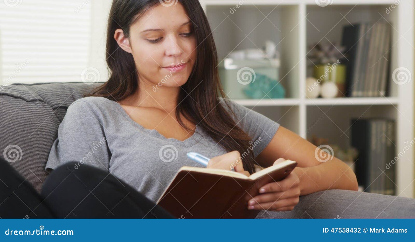 Hispanic Woman Sitting at Home Writing in Journal Stock Photo - Image ...