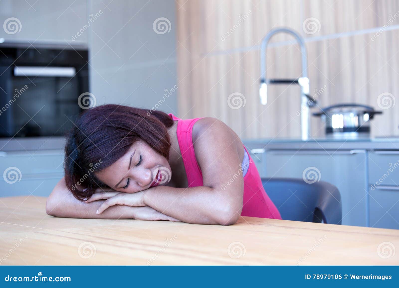 Hispanic Woman Sitting at Kitchen Table and Sleeping Stock Photo ...