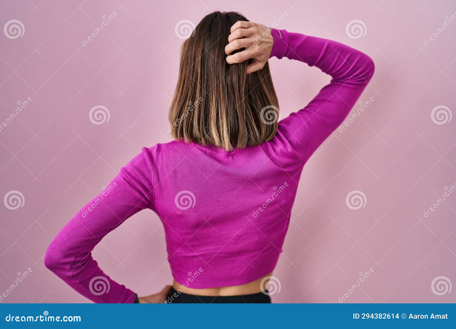 Hispanic Woman Standing Over Pink Background Backwards Thinking about ...
