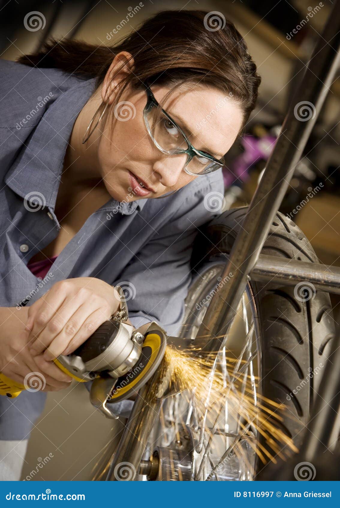 Hispanic Woman Using Grinder on Motorcycle Stock Image - Image of ...