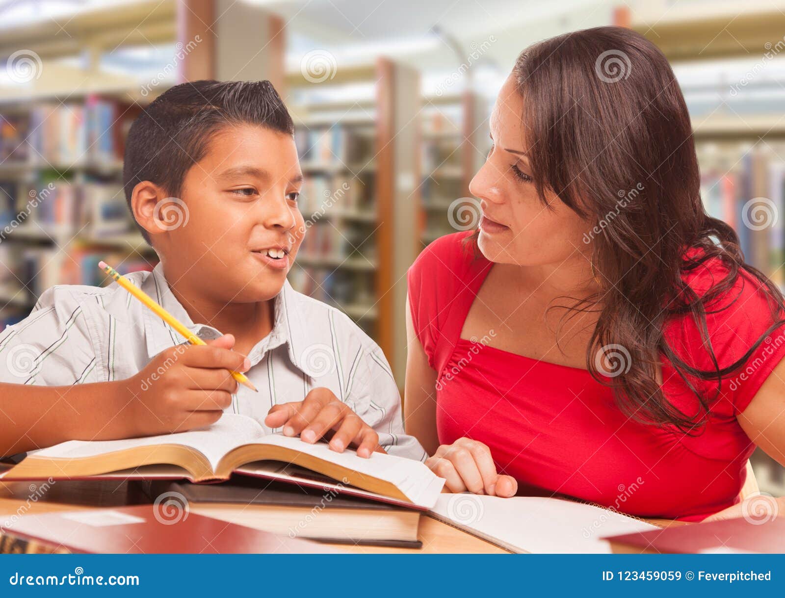 Hispanic Young Boy and Famle Adult Studying at Library Stock Image ...