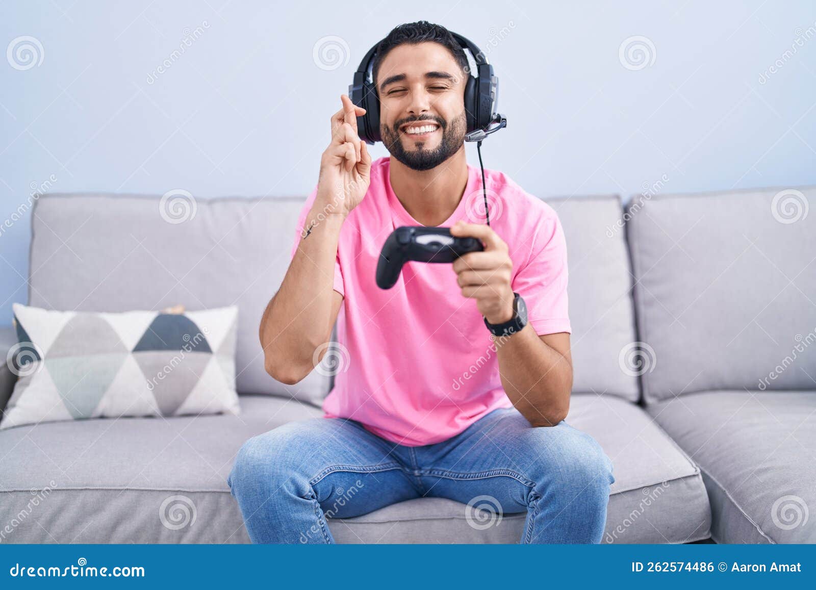 Hispanic Young Man Playing Video Game Holding Controller Sitting on the ...