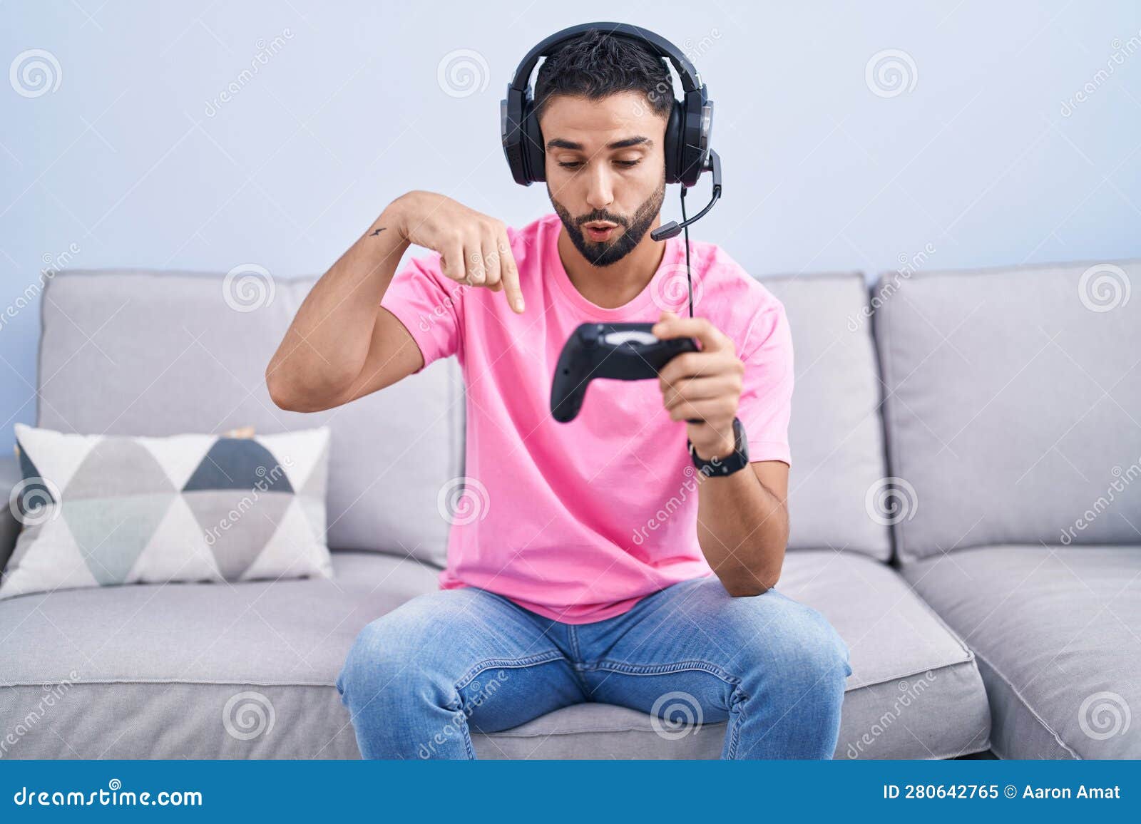 Hispanic Young Man Playing Video Game Holding Controller Sitting on the ...