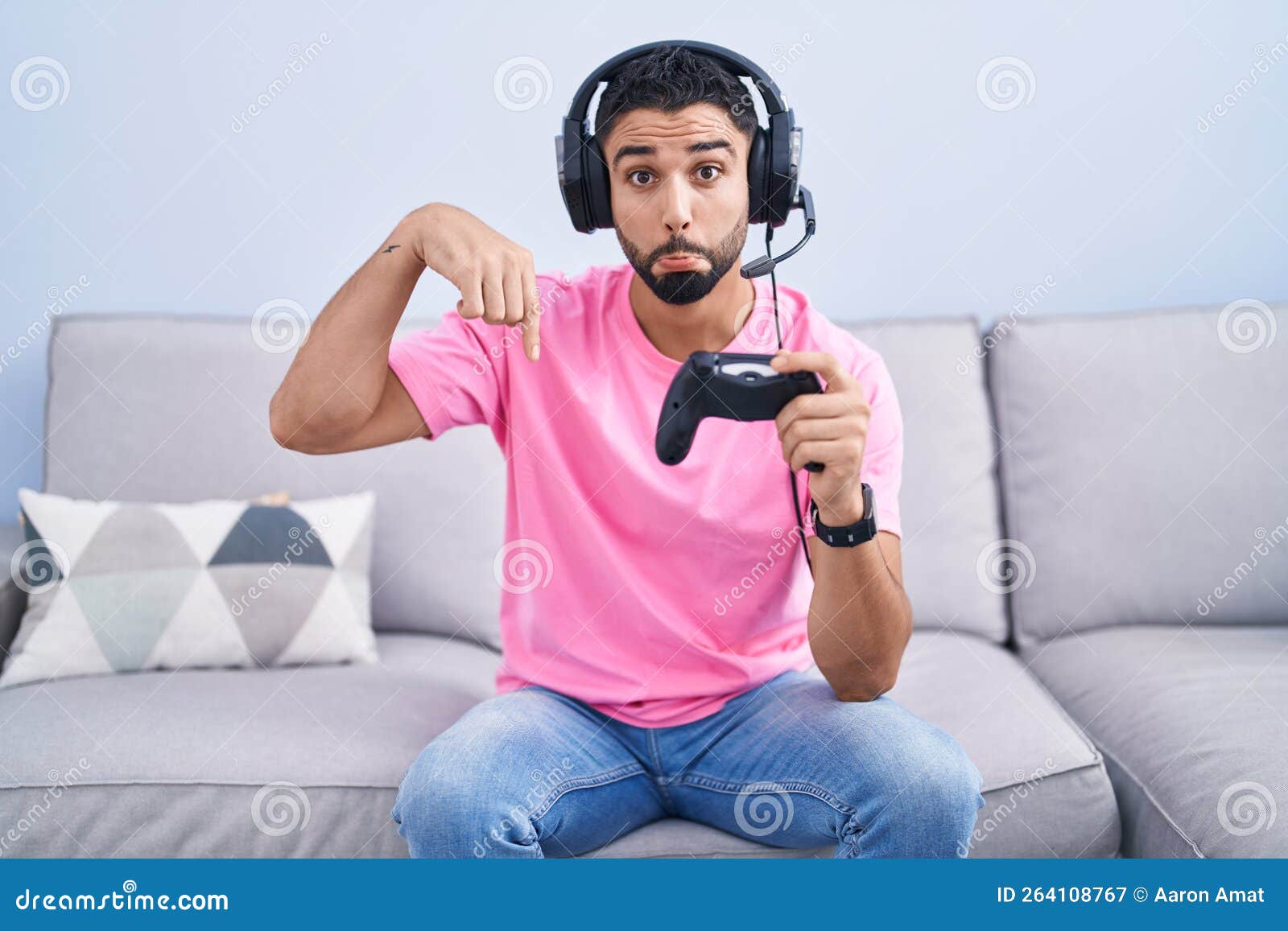 Hispanic Young Man Playing Video Game Holding Controller Sitting on the ...