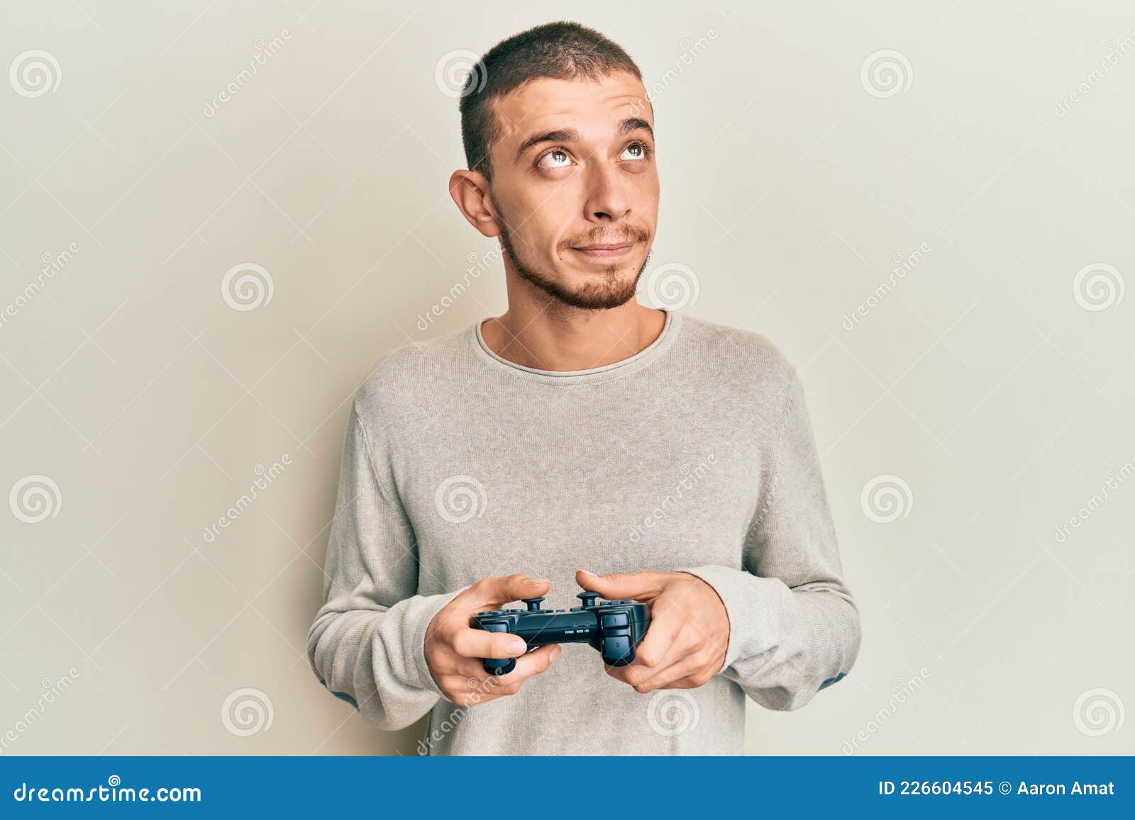 Hispanic Young Man Playing Video Game Holding Controller Smiling ...