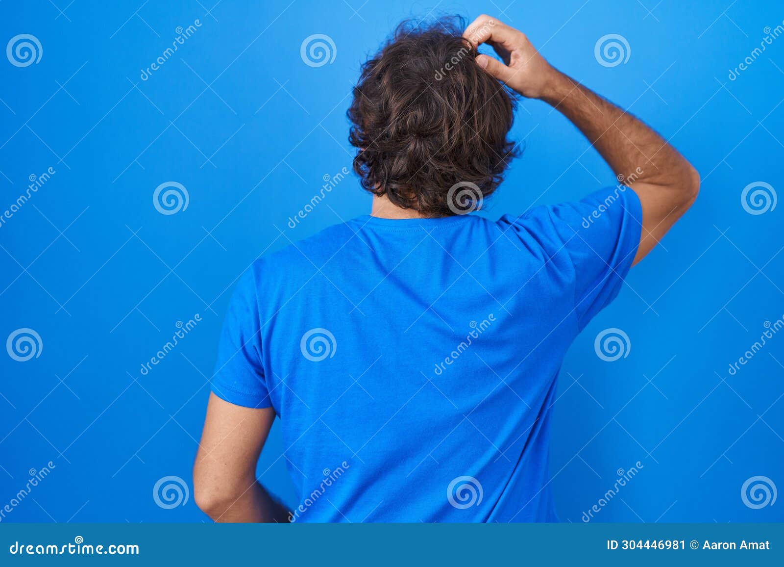 Hispanic Young Man Standing Over Blue Background Backwards Thinking ...
