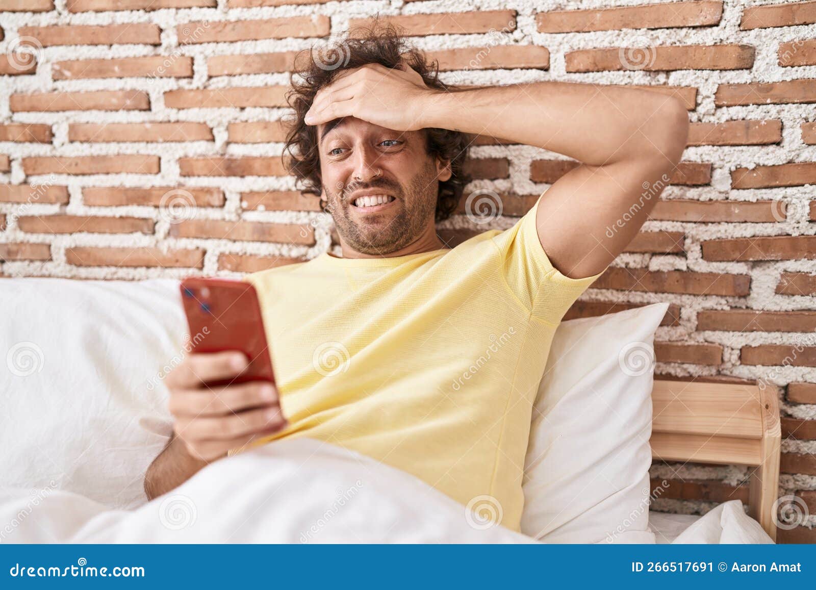 Hispanic Young Man Using Smartphone on the Bed Stressed and Frustrated ...