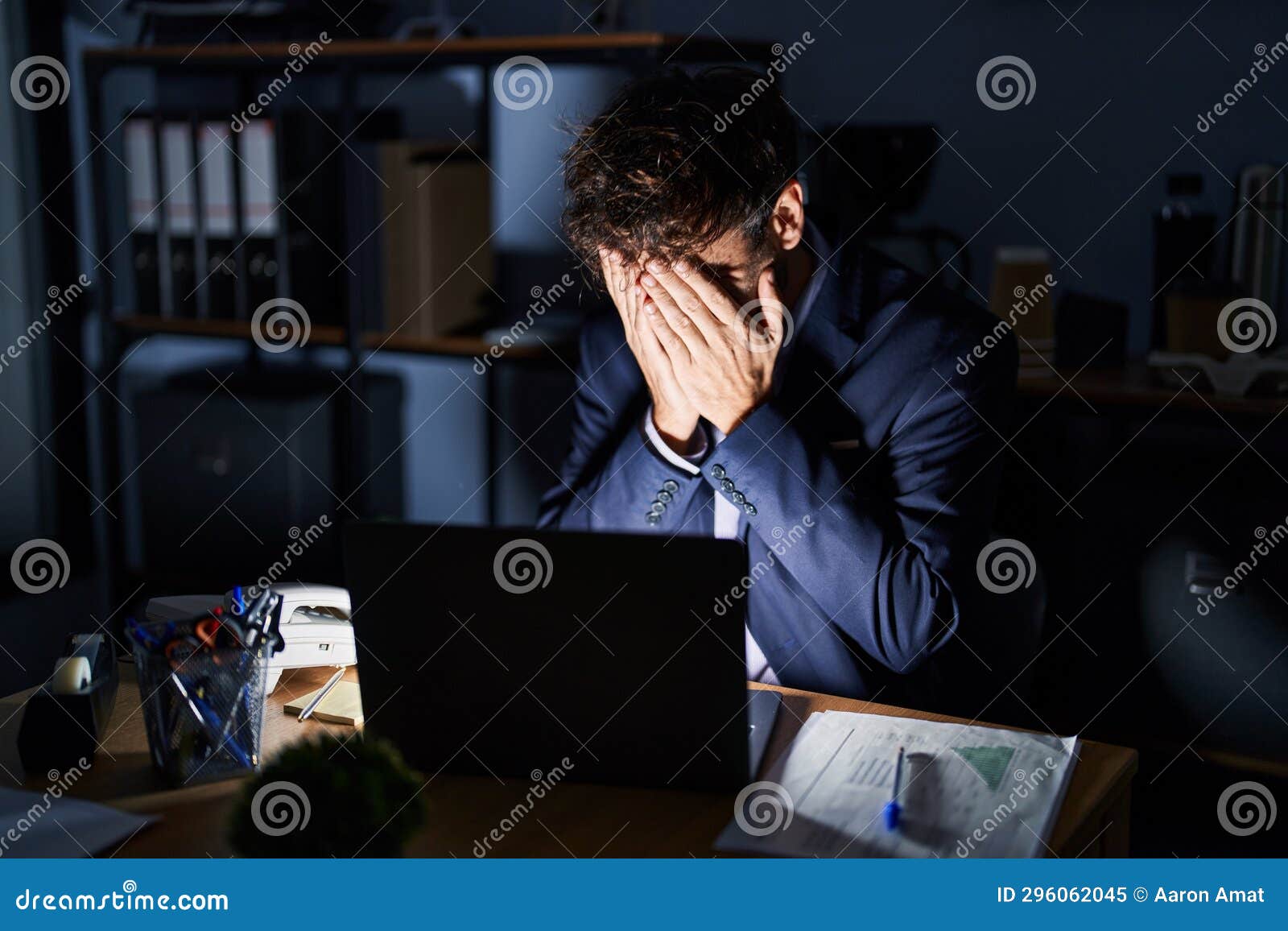 Hispanic Young Man Working at the Office at Night with Sad Expression ...