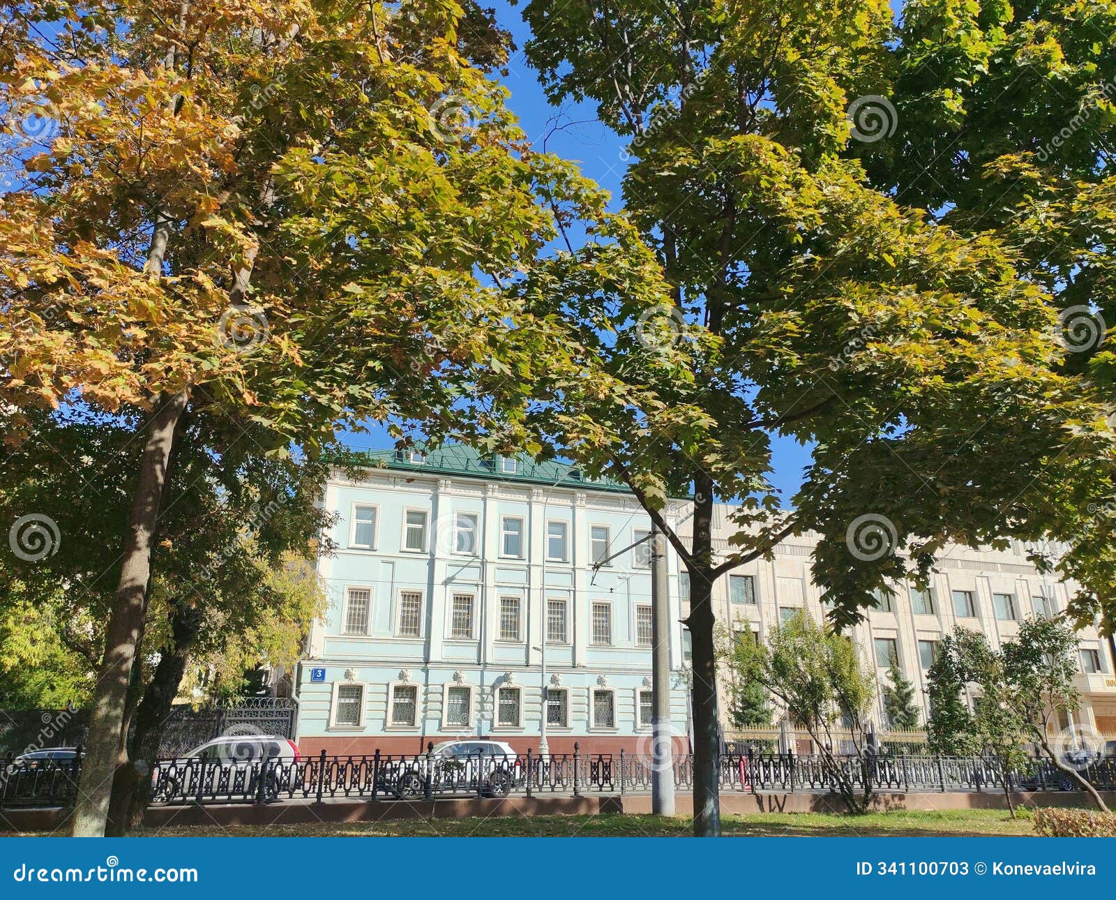 A Tall Stucco Chimney Shows Discoloration And Weathering, Rising Beside ...