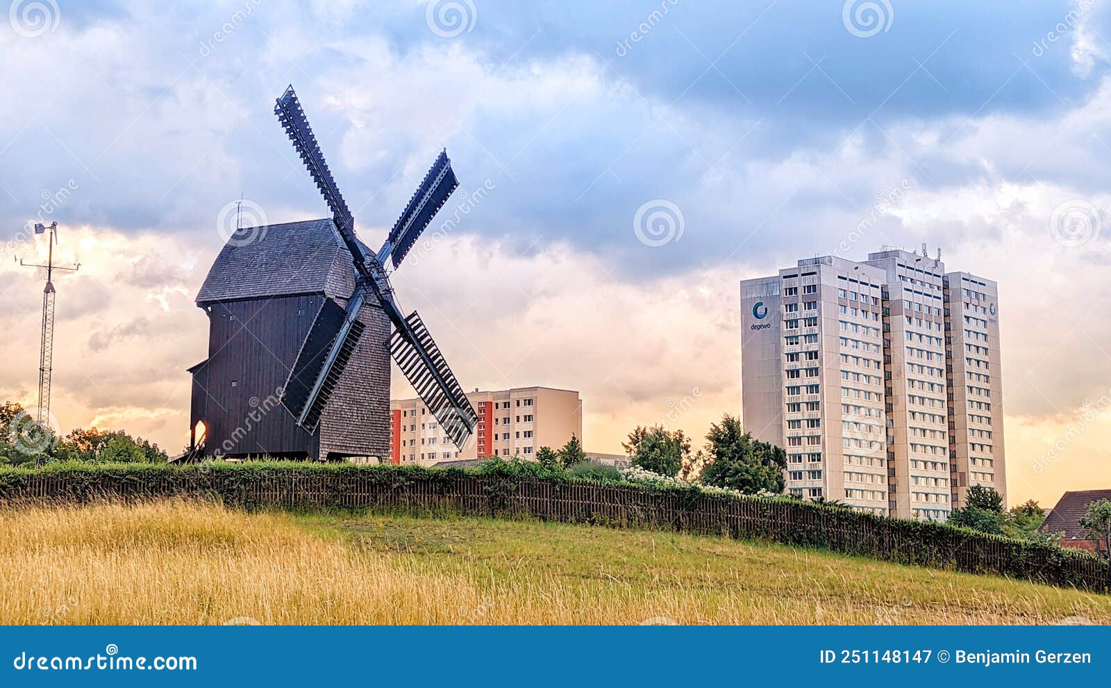 Historical Windmill in the City Surrounded by Modern High-rising Hoses ...