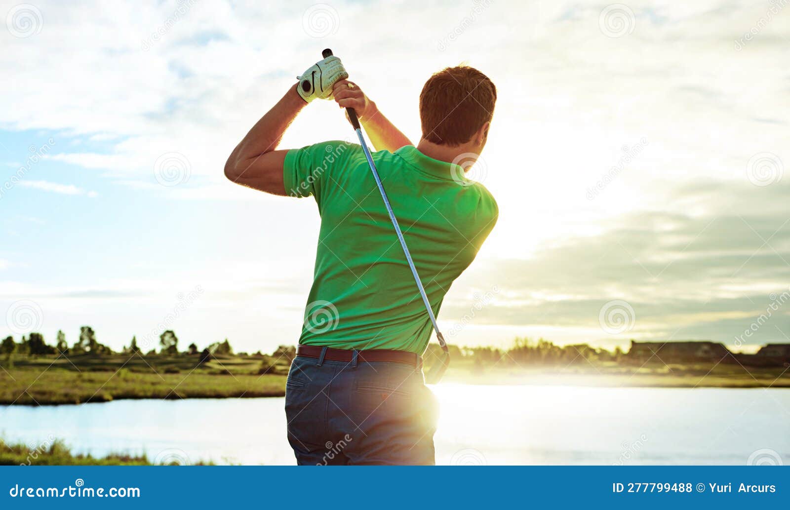 Hit Strong, Go Long. a Man Practicing His Swing on the Golf Course ...