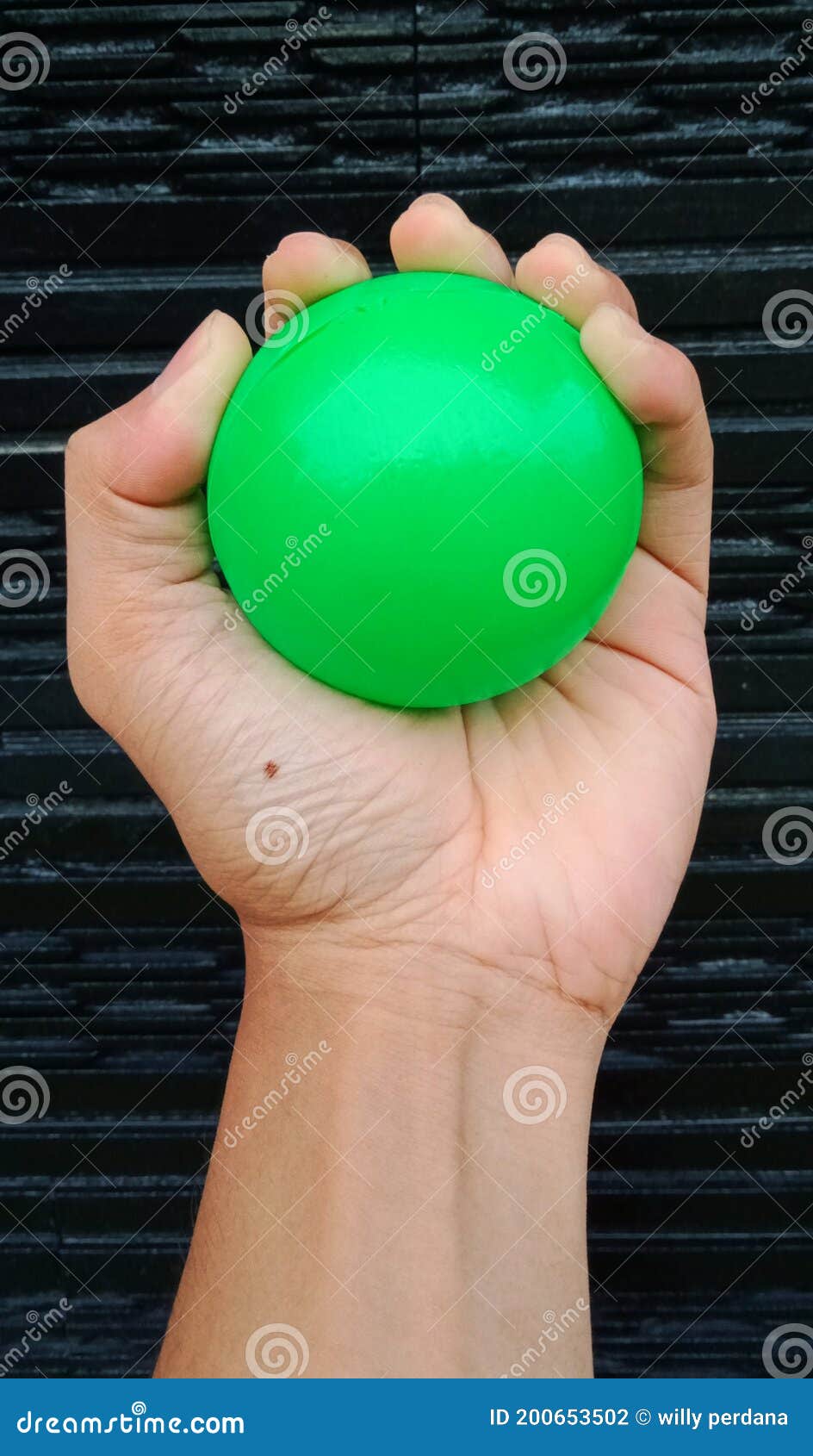 Hand holding a ball stock photo. Image of celebration - 200653502