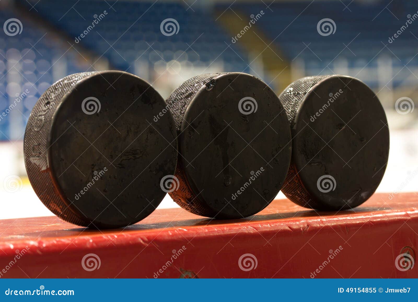Hockey Pucks on Bench stock image. Image of arena, national - 49154855
