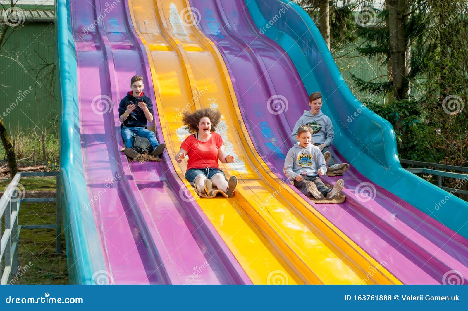 Children Rolling Down the Hill in the Amusement Park Editorial Stock ...