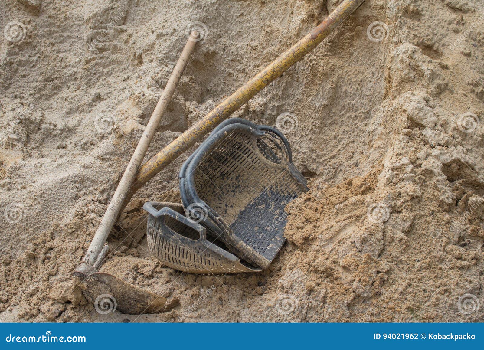 Hoe and basket on sand. stock photo. Image of equipment - 94021962