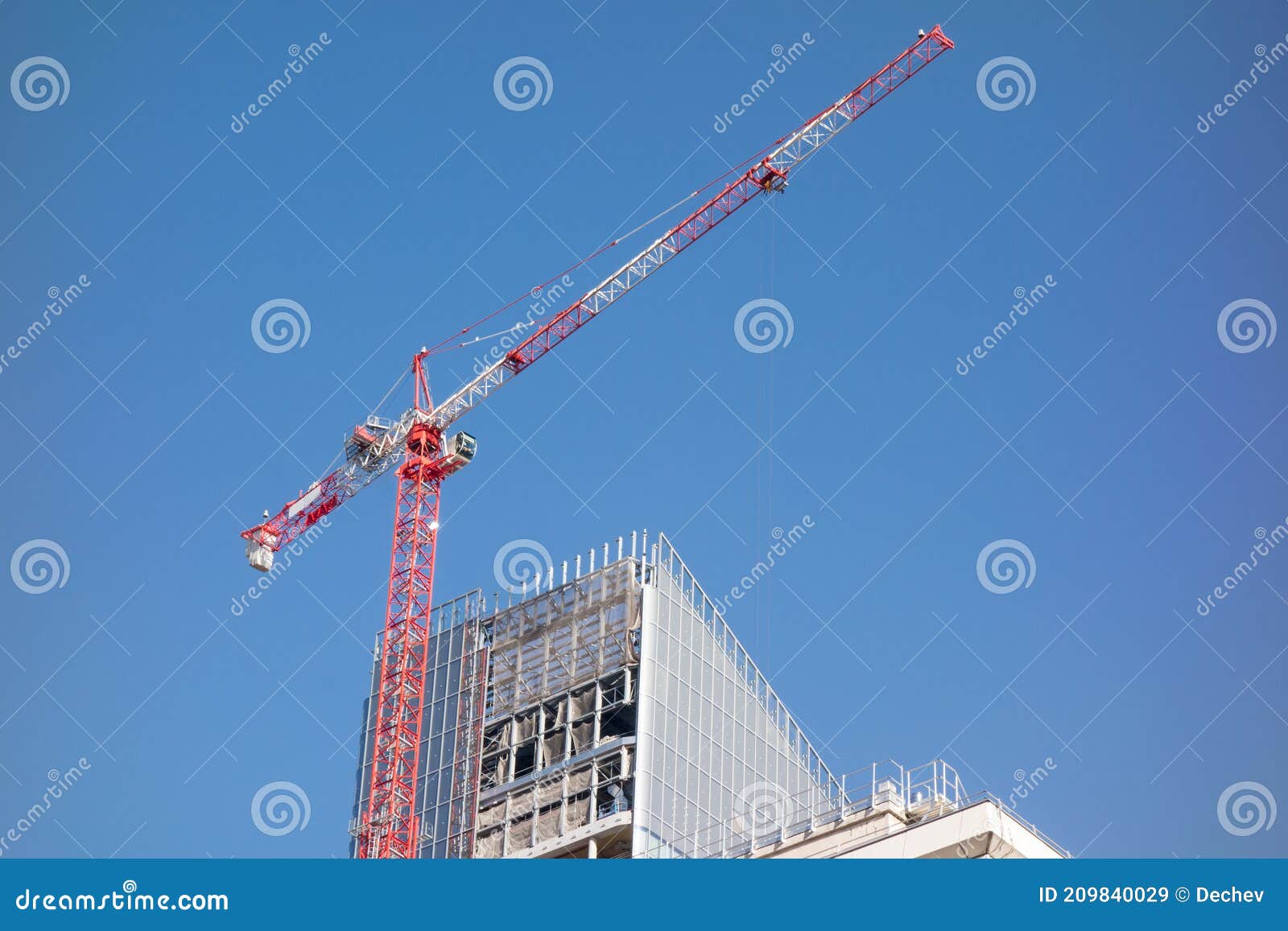 Hoisting Tower Crane on Top of Construction Skyscraper Building Over ...