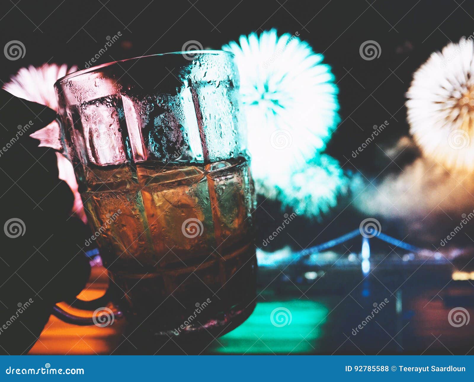 Hold a Glass of Beer Near the River, Can See Blooming Firework Stock ...