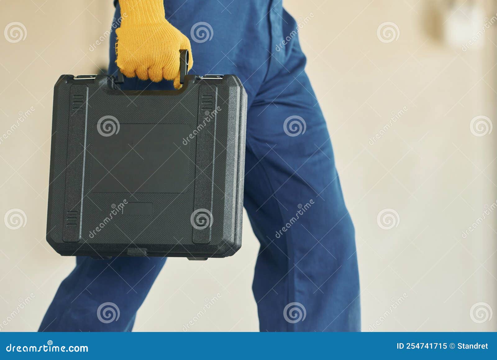 Holding Case. Young Man Working in Uniform at Construction at Daytime ...