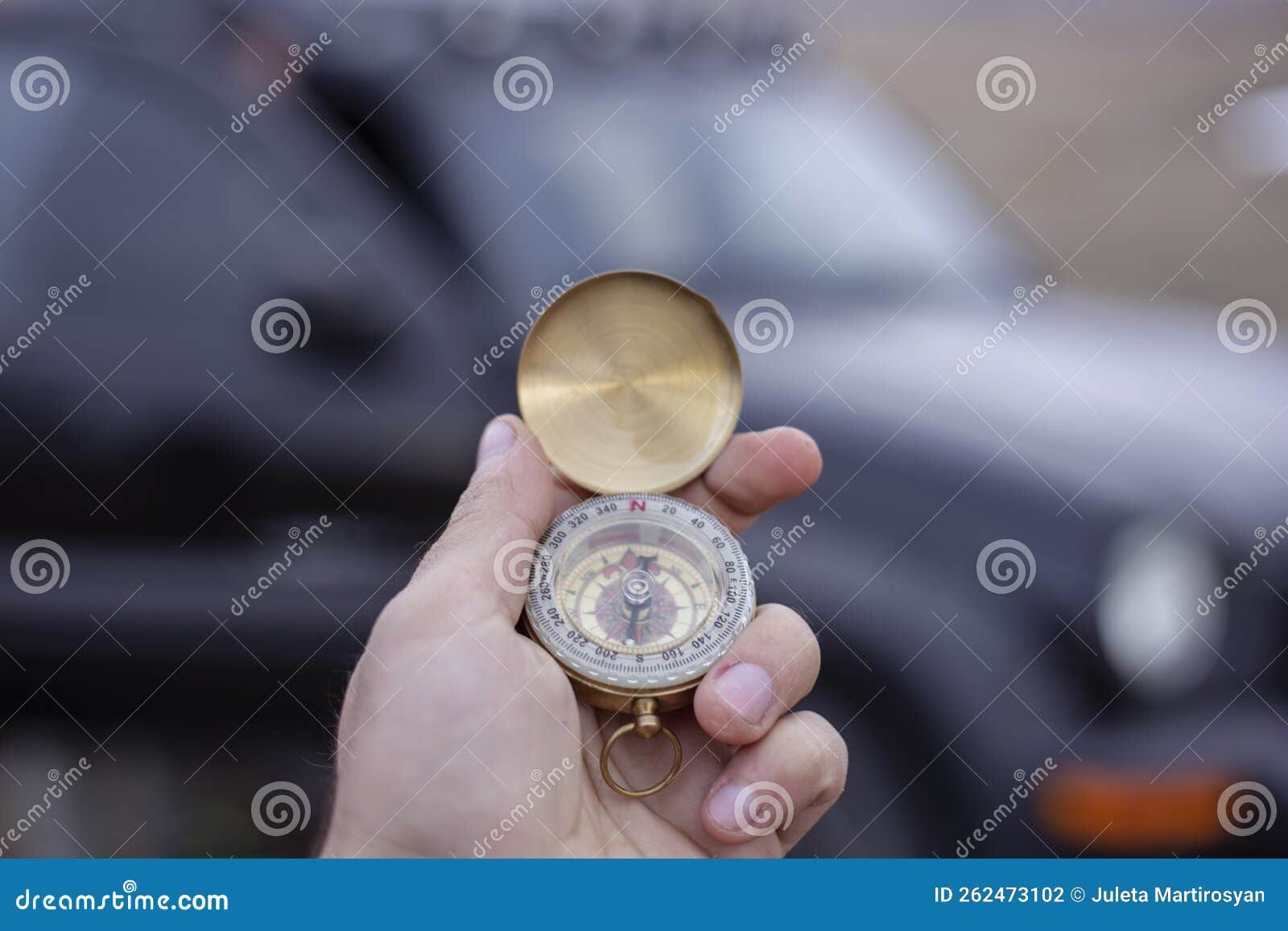 Holding a Compass in Front of a Car Stock Photo - Image of compass ...