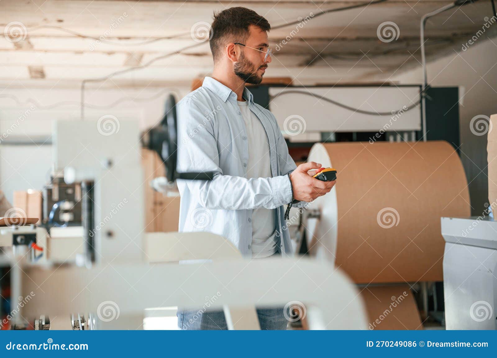 Holding Controller of Printing Machine. Polygraph Worker in White ...