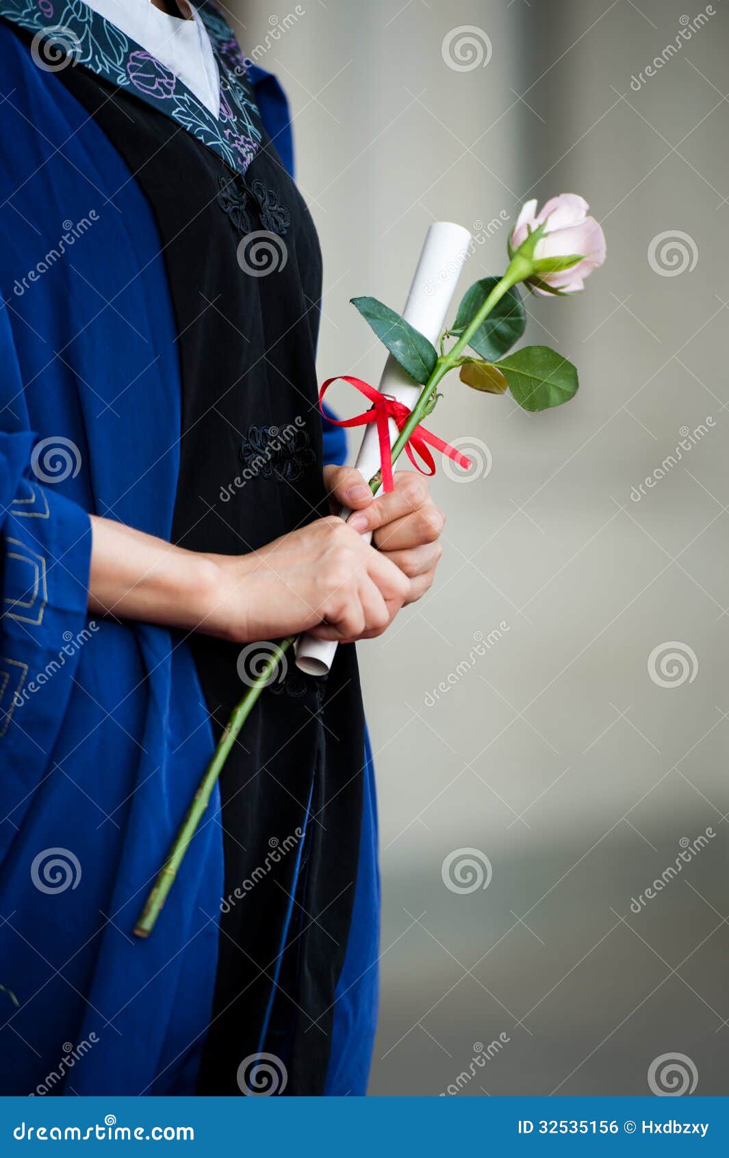 Holding a diploma and rose stock photo. Image of gown - 32535156