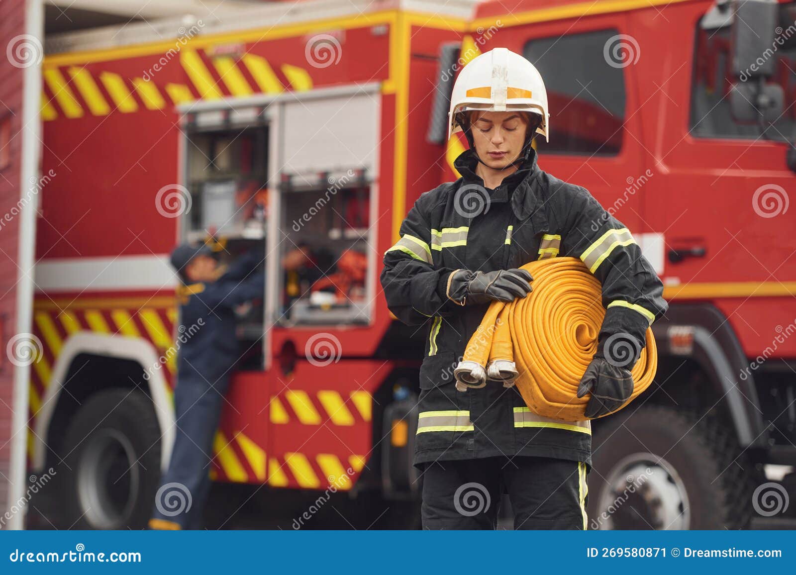 Holding Fire Hose. Woman in Uniform is at Work in Department Stock ...