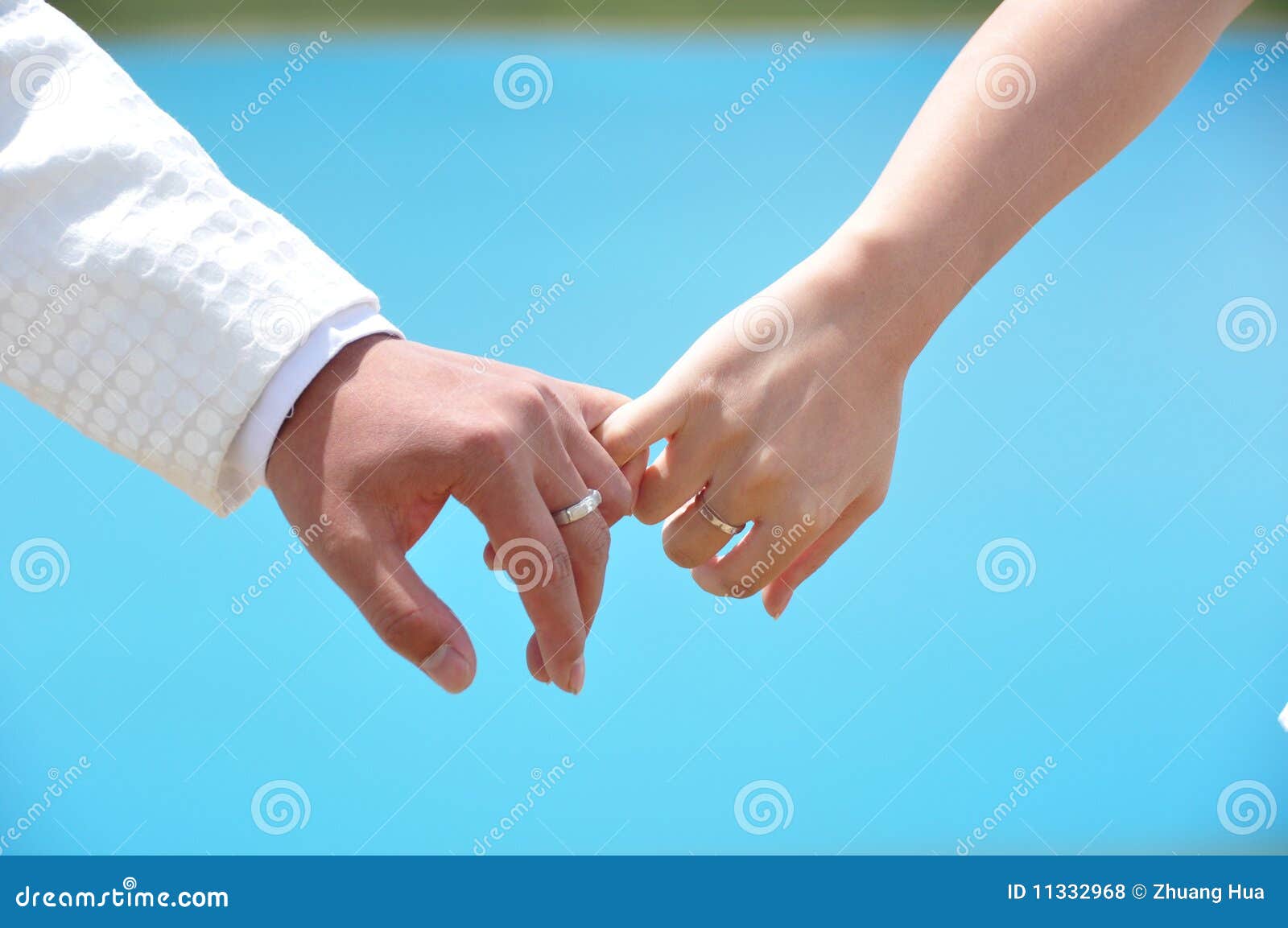 Holding Hands in Blue Background Stock Photo - Image of brides, couple ...
