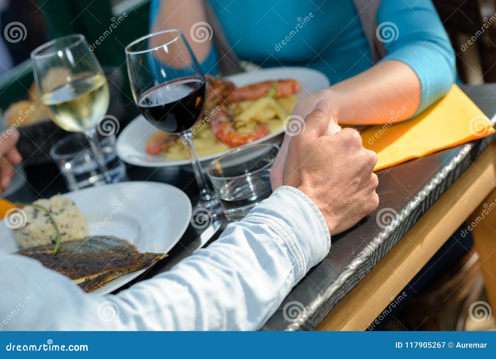 Holding hands over dinner stock image. Image of romance - 117905267