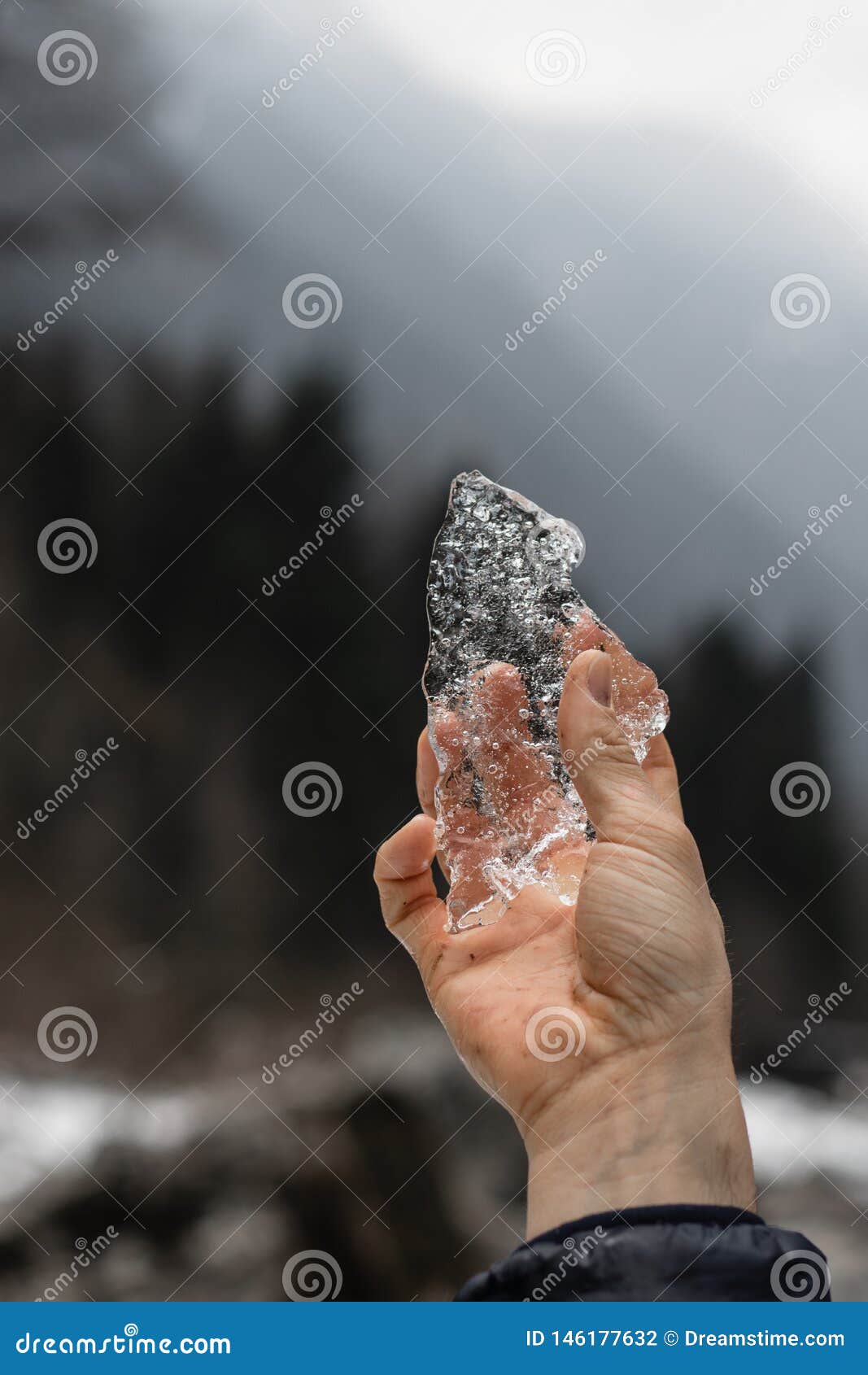 Holding a piece of ice stock photo. Image of fingers - 146177632