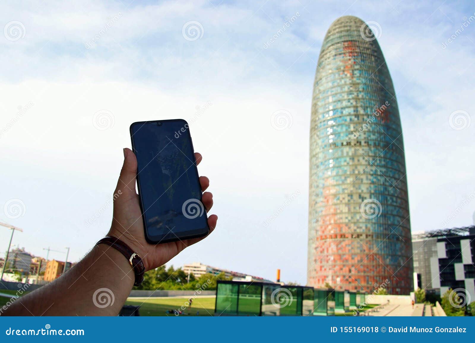 Holding a Mobile Phone in Front of a Modern Building. Stock Photo ...