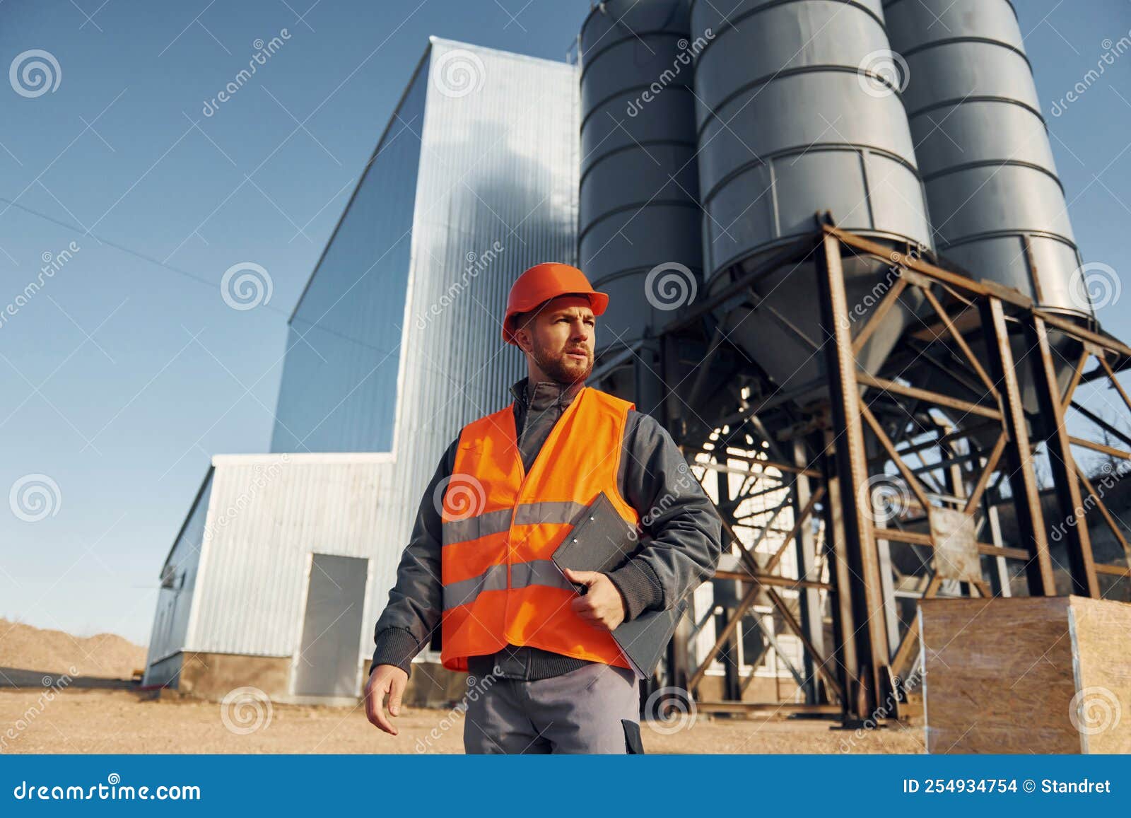 Holding Notepad in Hands. Construction Worker in Uniform is Outdoors ...