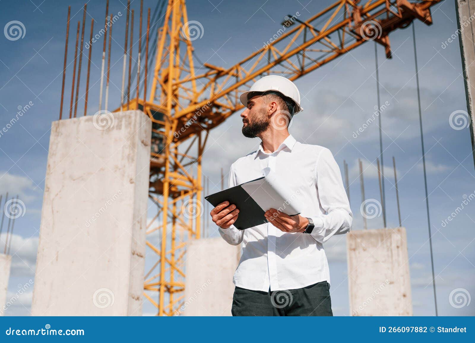 Holding Notepad. Man in Uniform is Working on the Construction Site ...