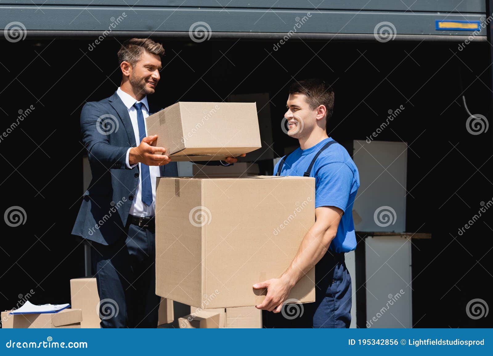 Holding Package Near Loader with Carton Stock Photo - Image of uniform ...