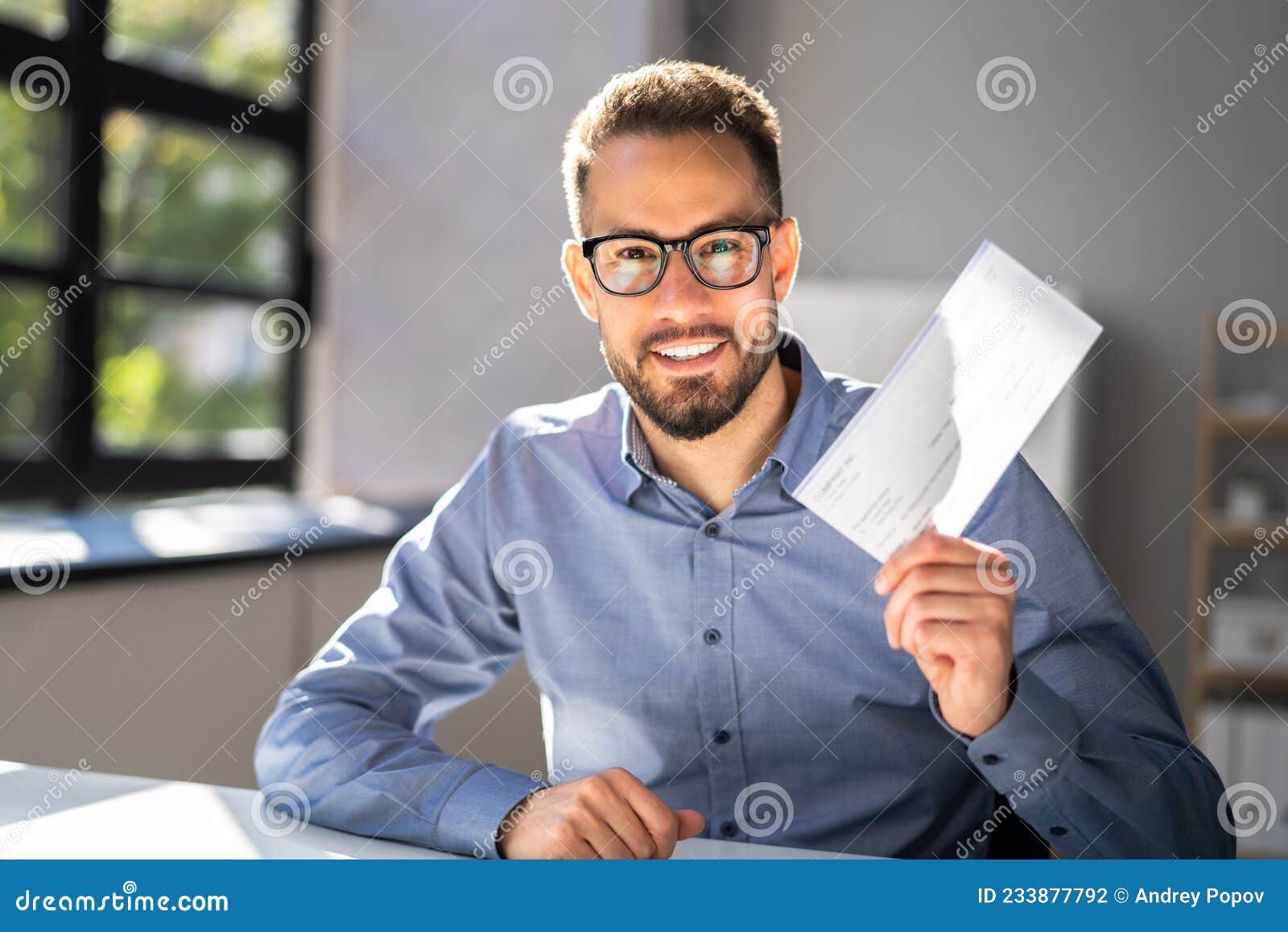 Holding Paycheck or Payroll Check or Insurance Cheque Stock Photo ...
